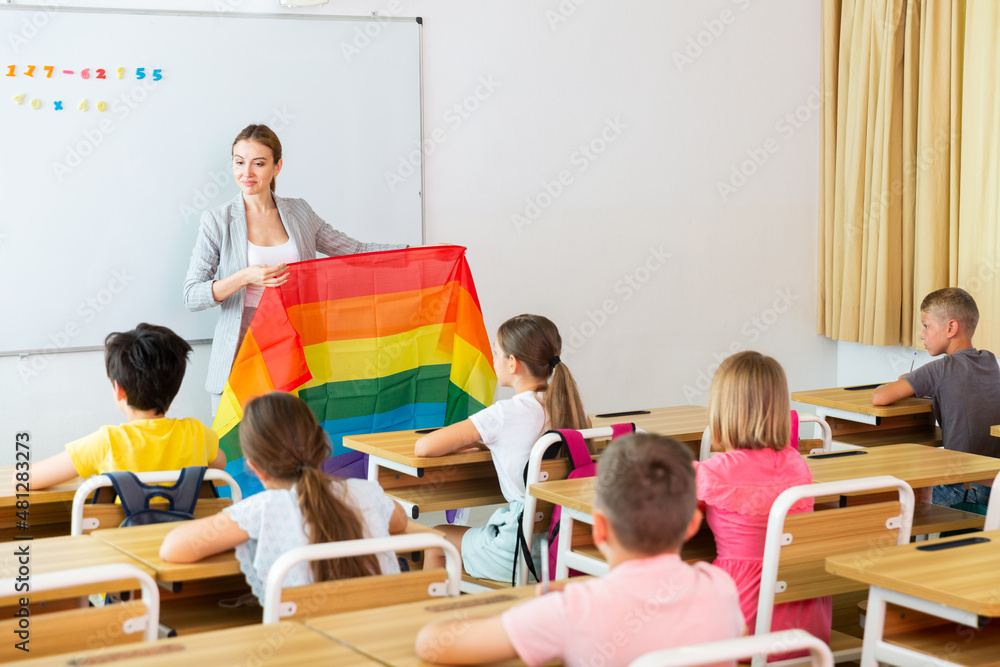 Portrait of smiling young female teacher conducting lesson for tweens ...