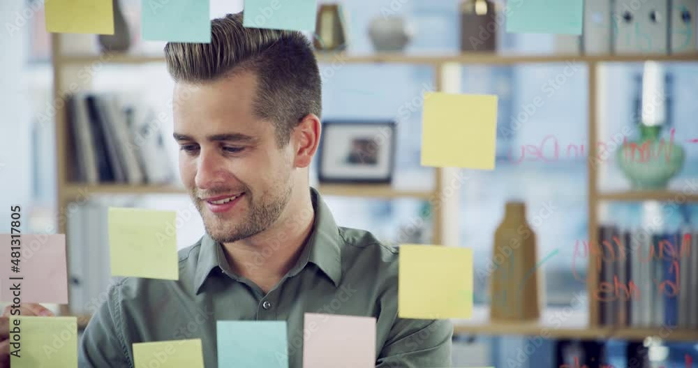 Young businessman having a brainstorming session a glass wall in a ...