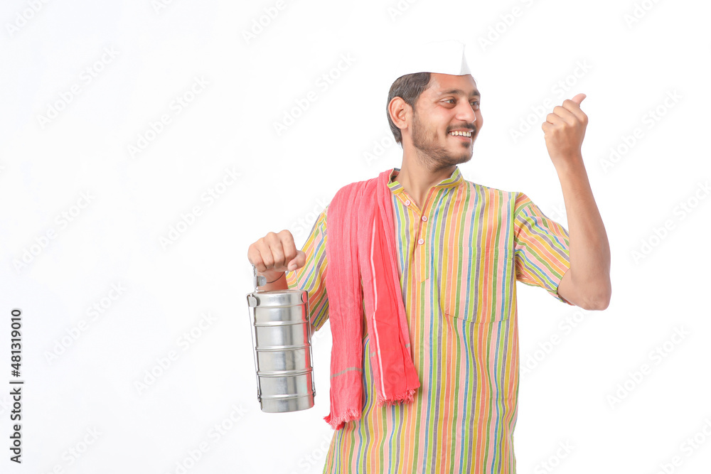 Young indian common man in traditional wear holding tiffin box in hand ...