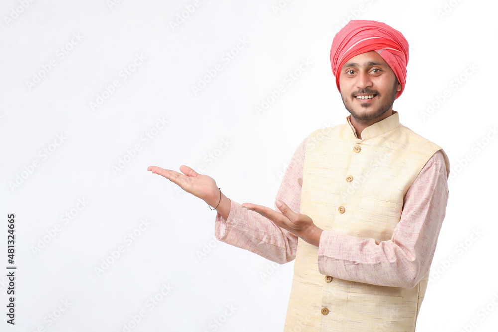 Young indian man in traditional wear and giving expression on white ...