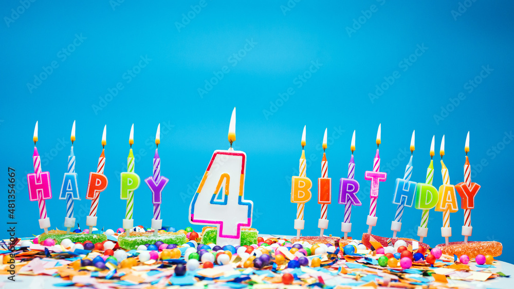 Happy birthday candle letters with number four on a beautiful blue ...