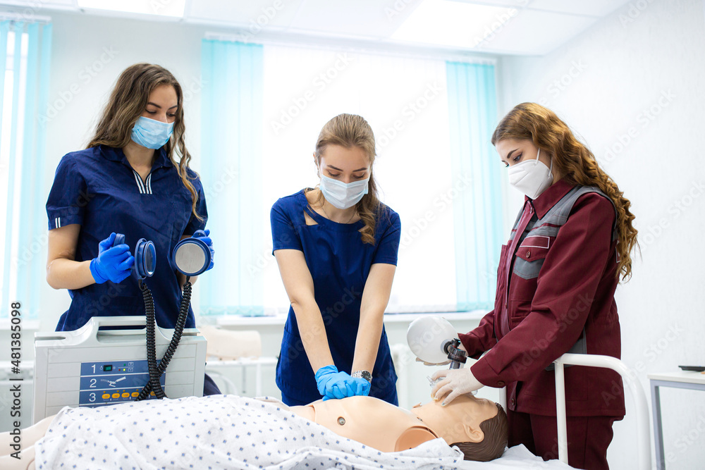CPR first aid with AED Training Concept. Paramedic demonstrates ...