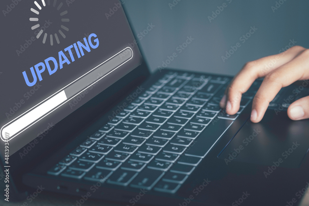 Installing software update process, operating system upgrade concept. Hand using laptop with ...