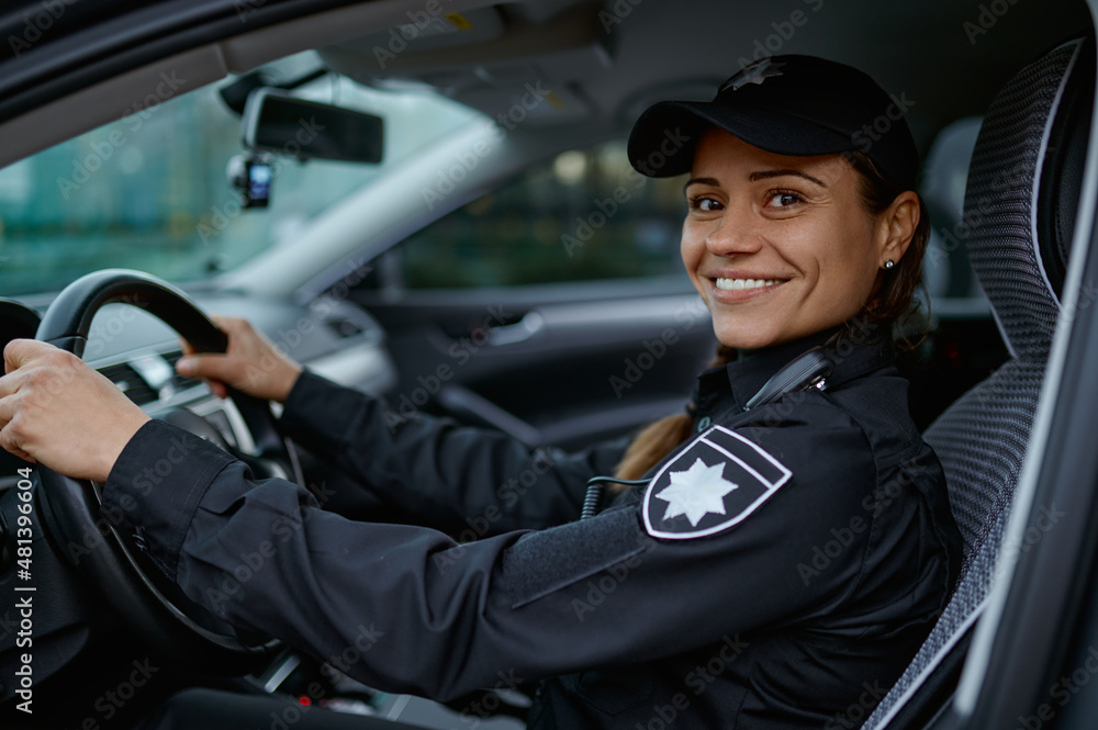 Side view portrait police woman driving car Stock Photo | Adobe Stock