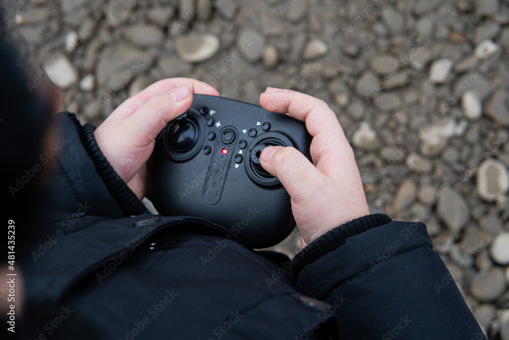remote control for a radio-controlled model in the hands of a child ...
