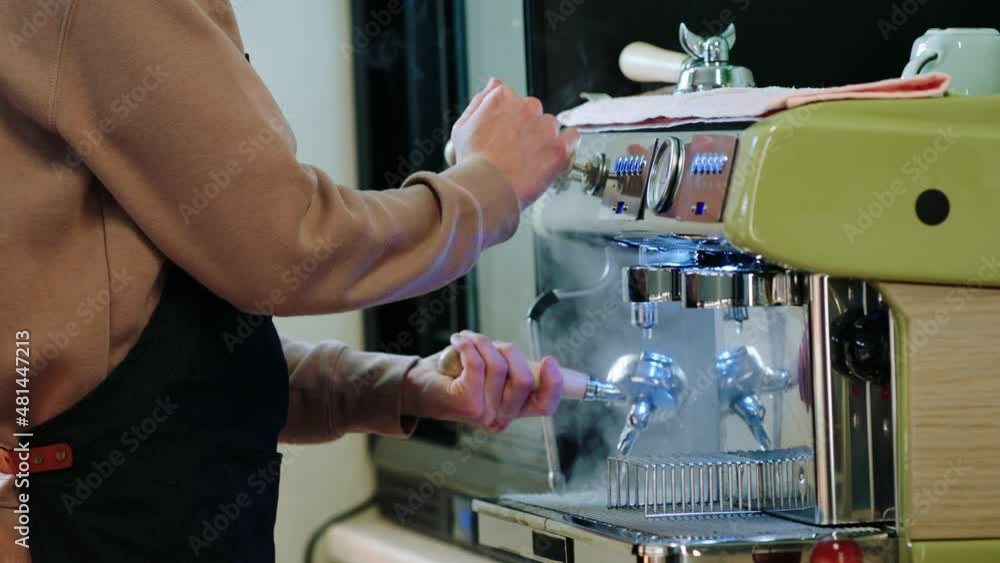 In the Coffee shop barista washing the parts of coffee machine ...