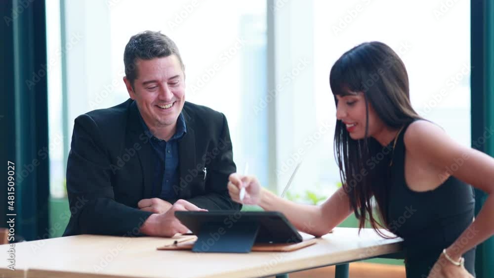 Hispanic male insurance agent consulting clients and signing of the ...