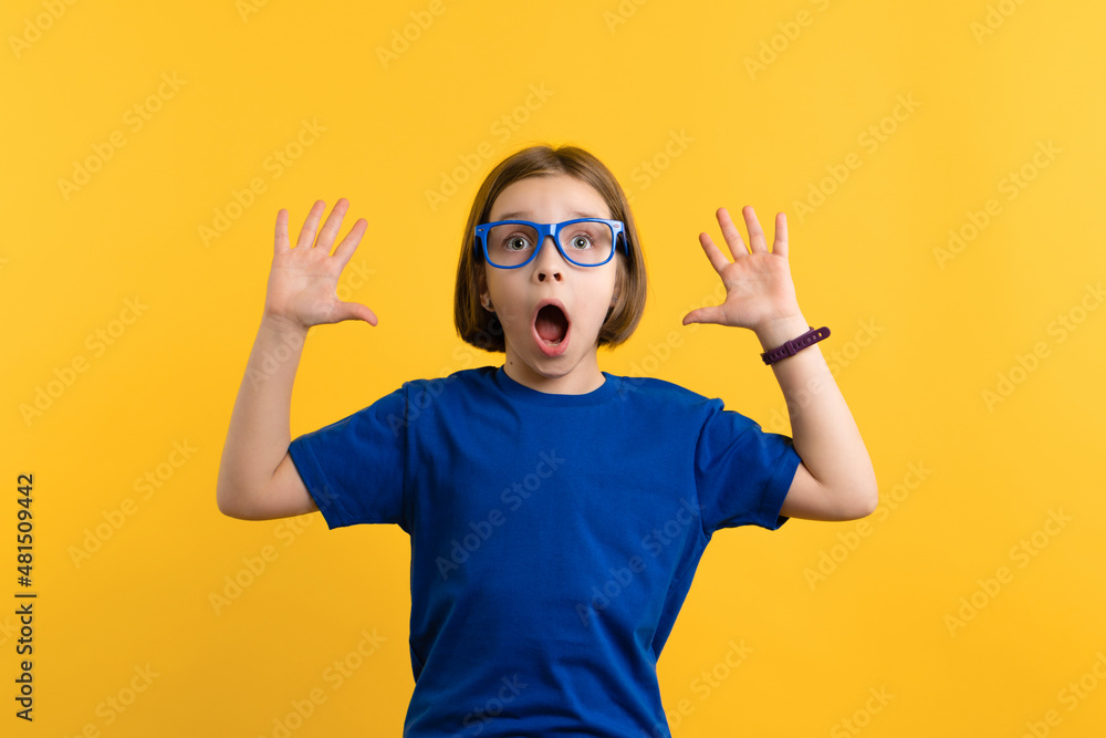 little-girl-8-10-years-old-in-blue-t-shirt-and-eyeglasses-on-yellow