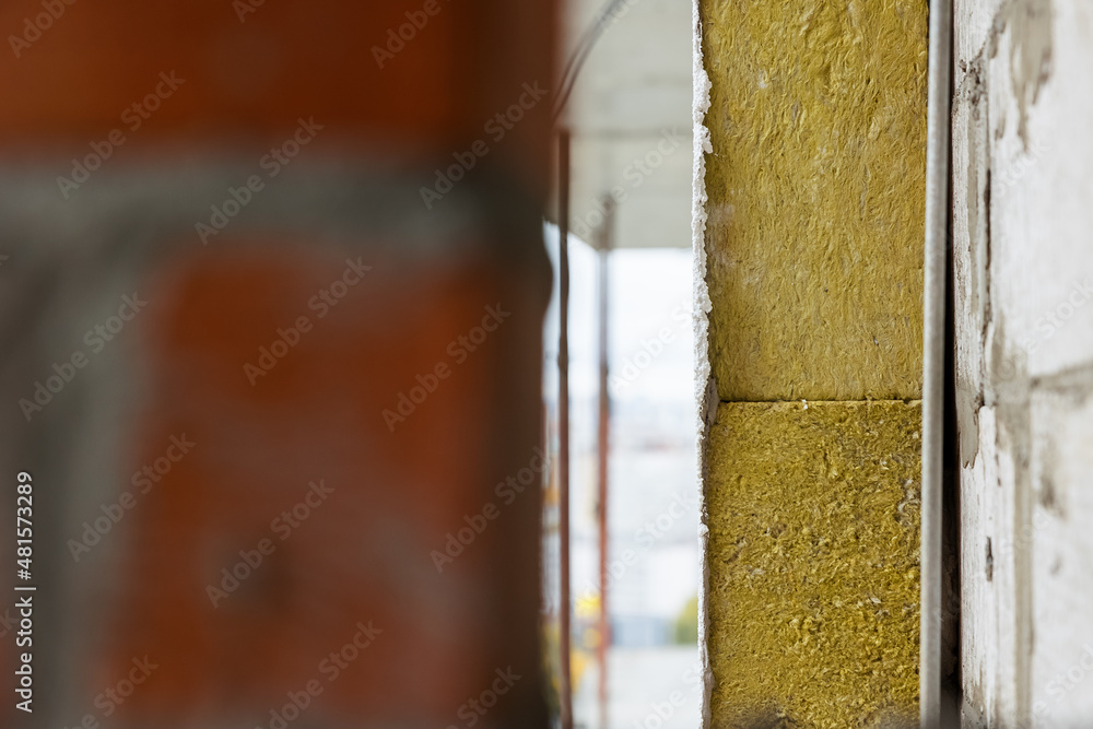 stone wool insulation installed on the wall of the building and covered ...