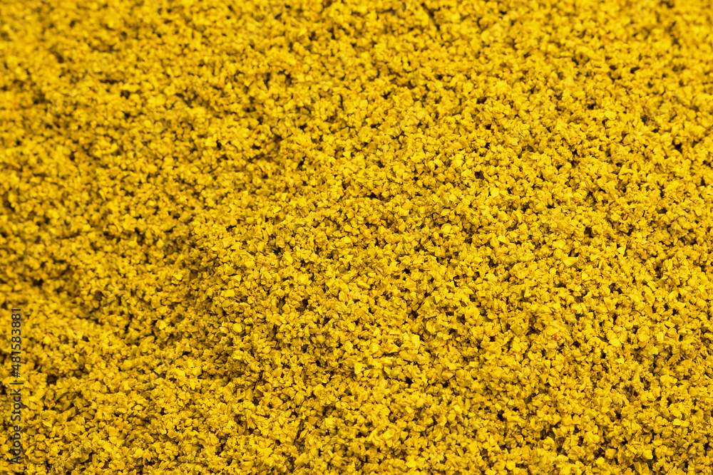 yellow rubber crumb mixed with adhesive and ready to be applied to the ...