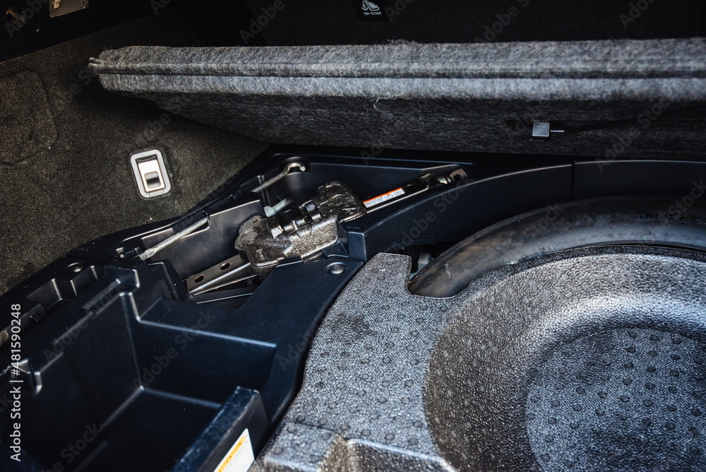 Spare wheel in the trunk of a modern car. Clean trunk of the SUV ...