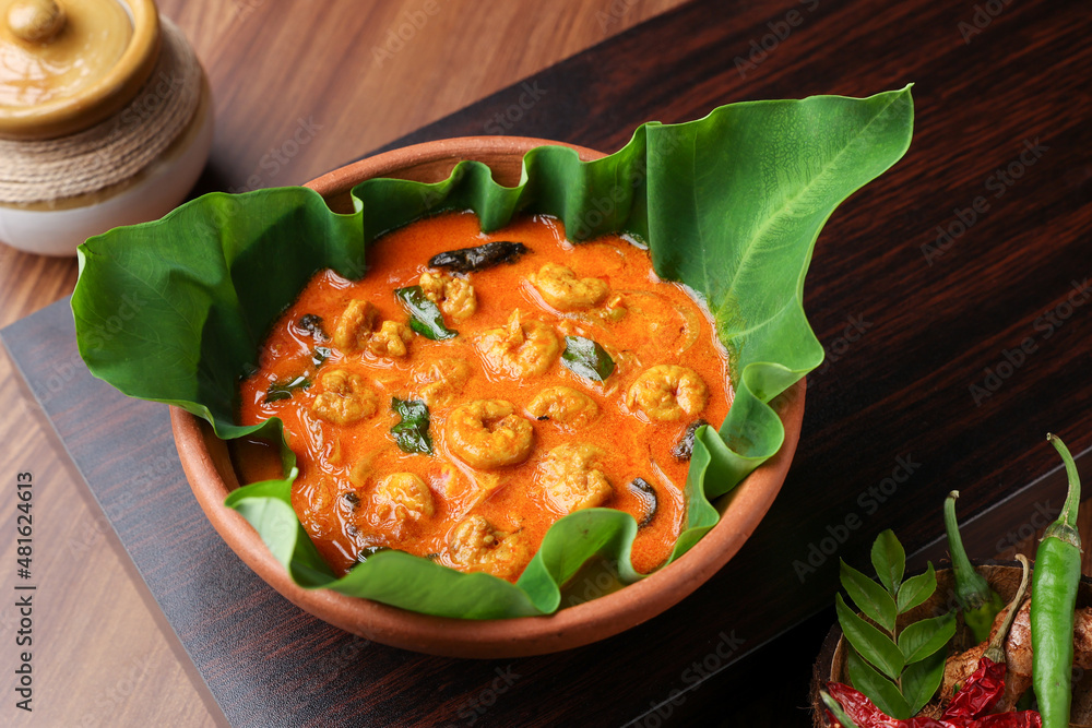 Serving Shrimp masala fish curry Chemmeen curry in coconut milk tiger ...