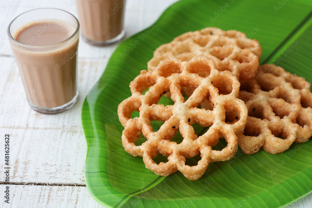 Achappam Rosette Cookie Indian milk masala tea traditional popular deep fried snack at tea time ...