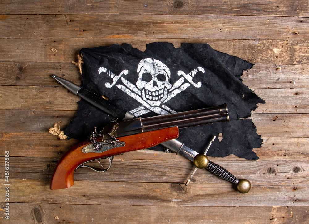 crossed antique flintlock pistol and large pirate dagger and jolly ...