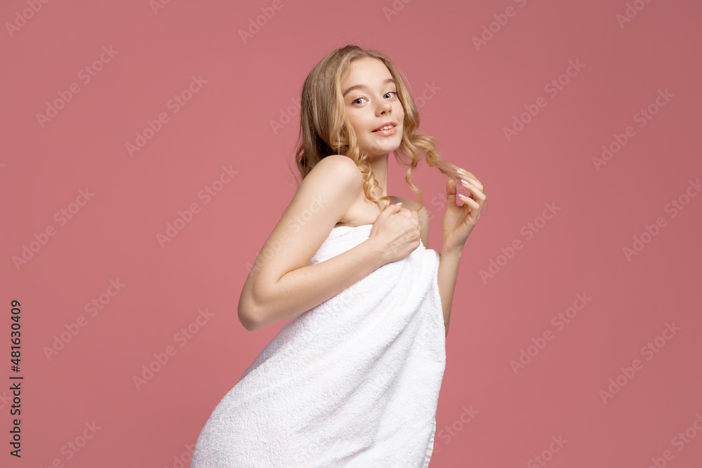 Half-length portrait of young beautiful slim girl in white towel posing ...