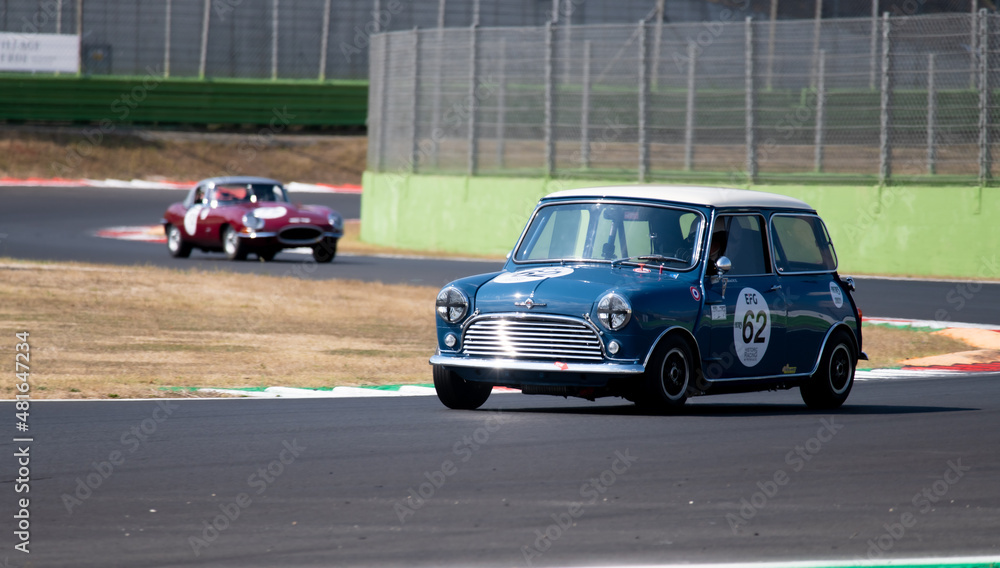 60s vintage race car competition on racetrack, Morris Mini Cooper Stock ...