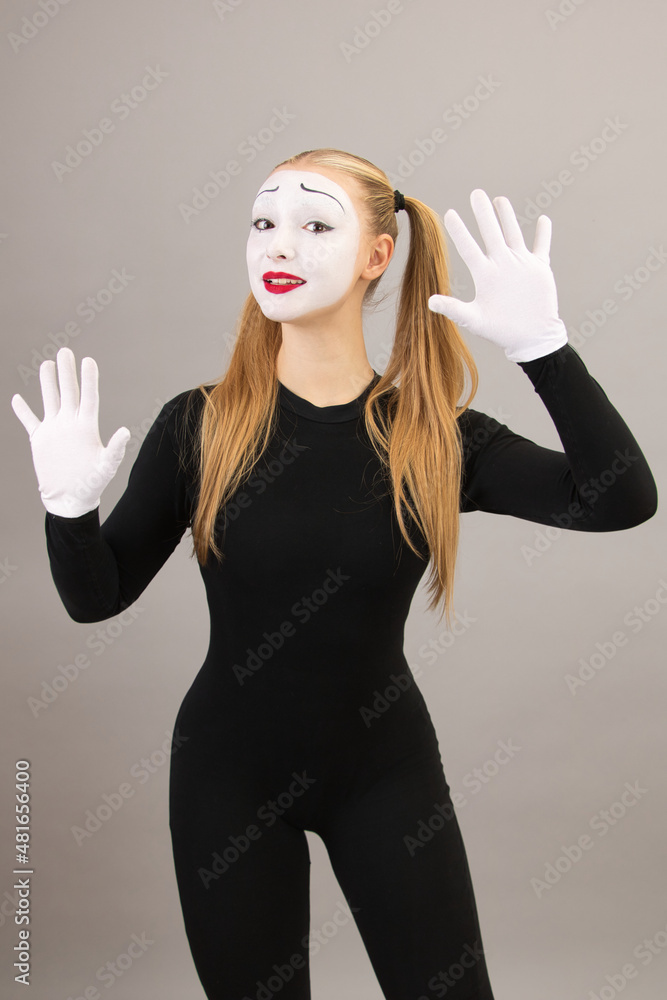 The clown in the role of pantomime shows a touch to an invisible wall ...