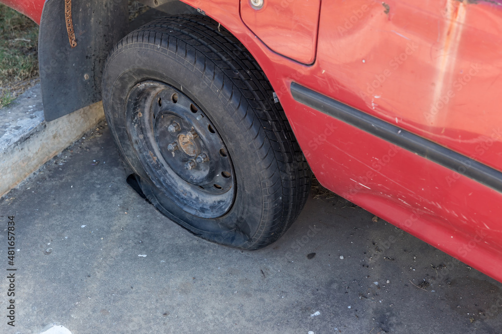 Destroyed blown out tire with exploded, shredded and damaged tire on a ...