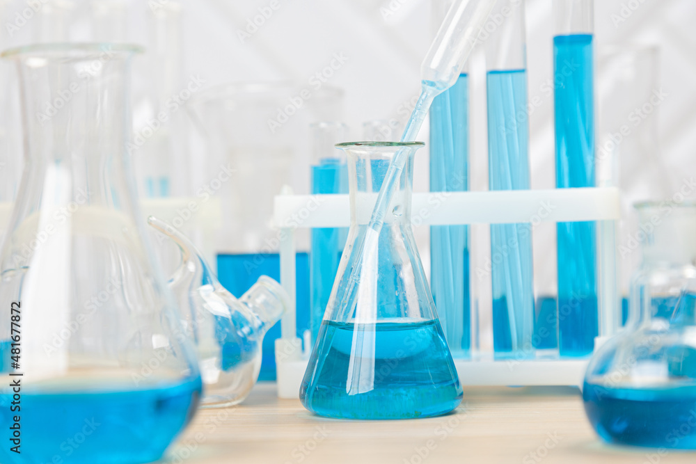 Laboratory glassware with test tubes. flasks, dropper, petri dishes ...