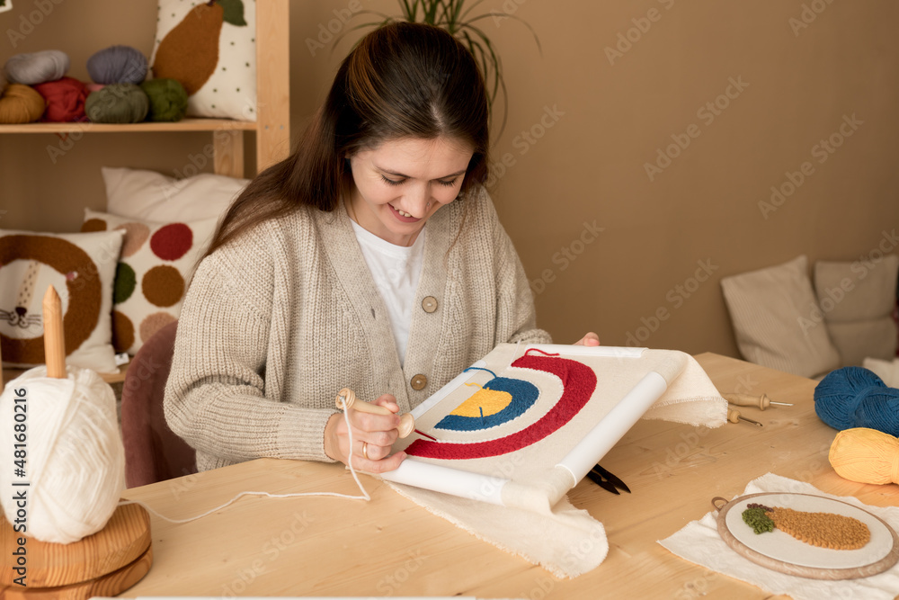 Punch needle embroidery. Young woman pushing the punchneedle straight ...