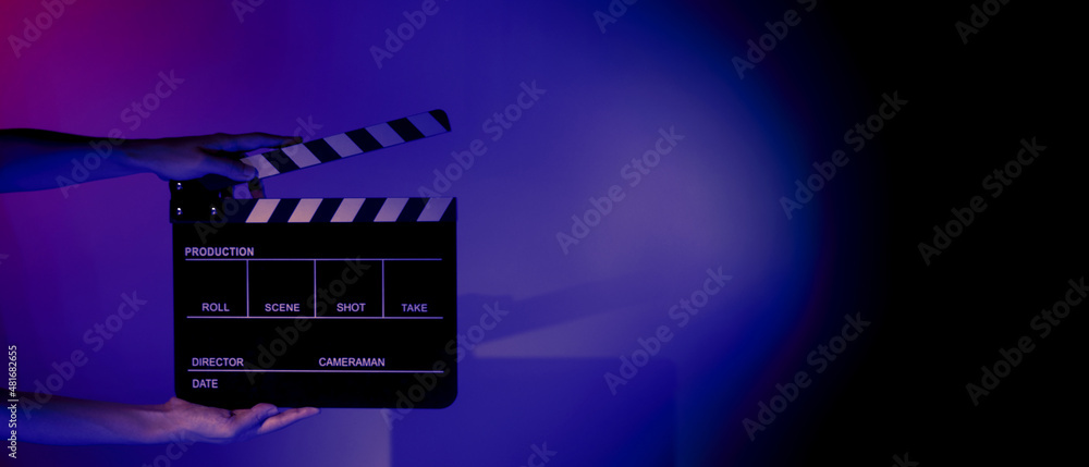 Blurry images of movie slate or clapper board. Hand holds empty film ...