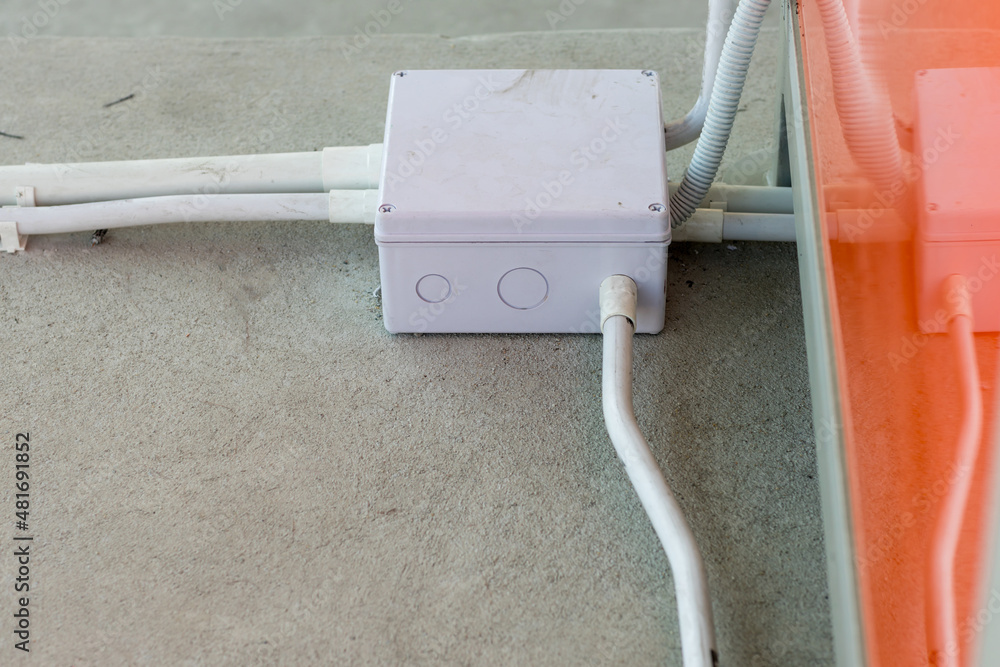 Square Flooring box with plastic pipes and electric cables. White ...