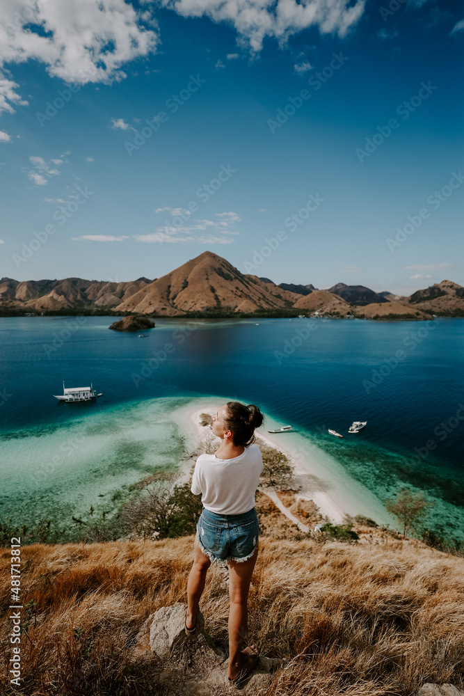 A young female traveler is exploring tropical island in Komodo ...