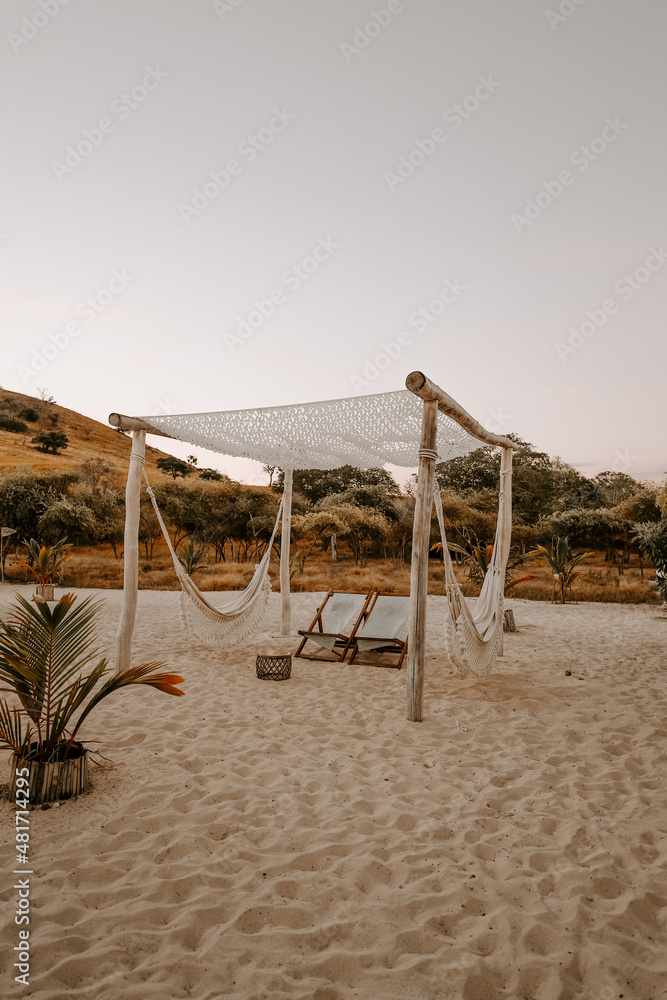 A relaxing scene of a secluded and peaceful beach setup, hammock ...