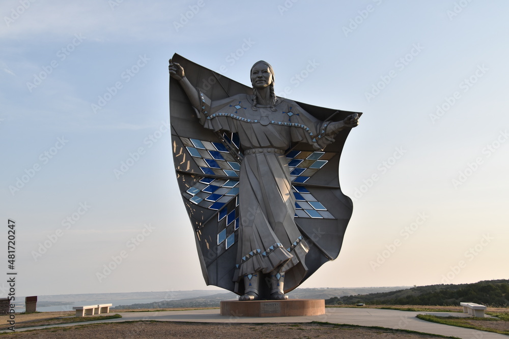 Dignity" statue depicting a Native American woman holding a star quilt ...