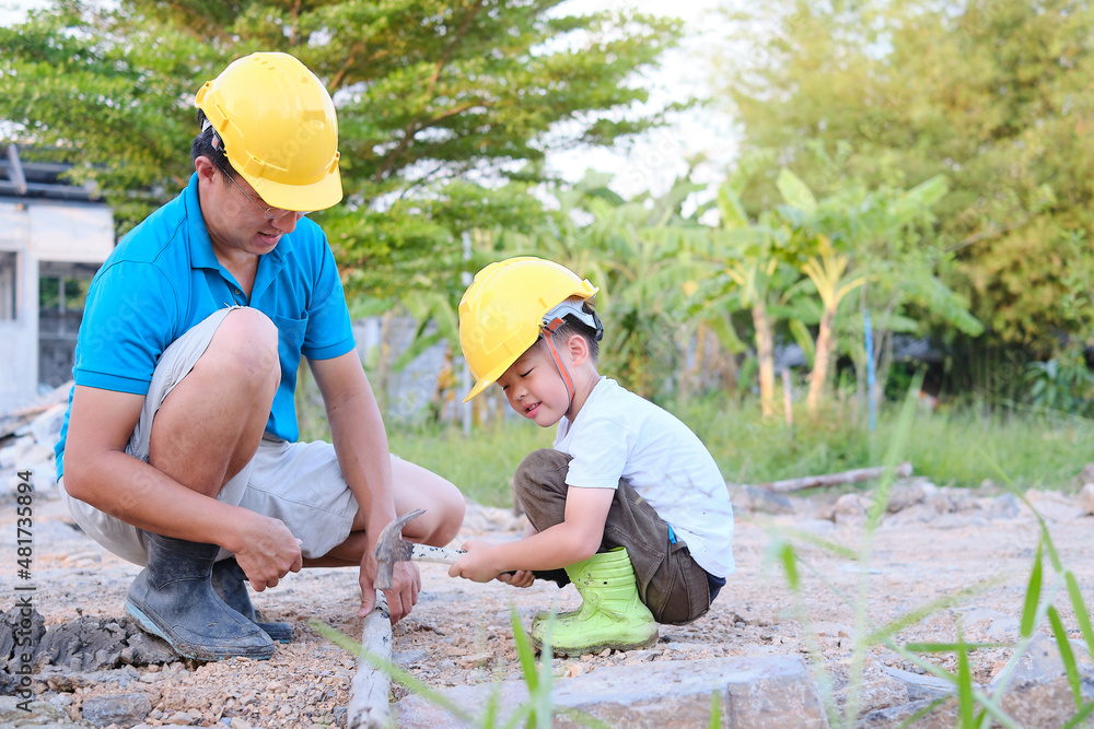 Happy Asian Dad and son wearing yellow construction helmet or safety ...