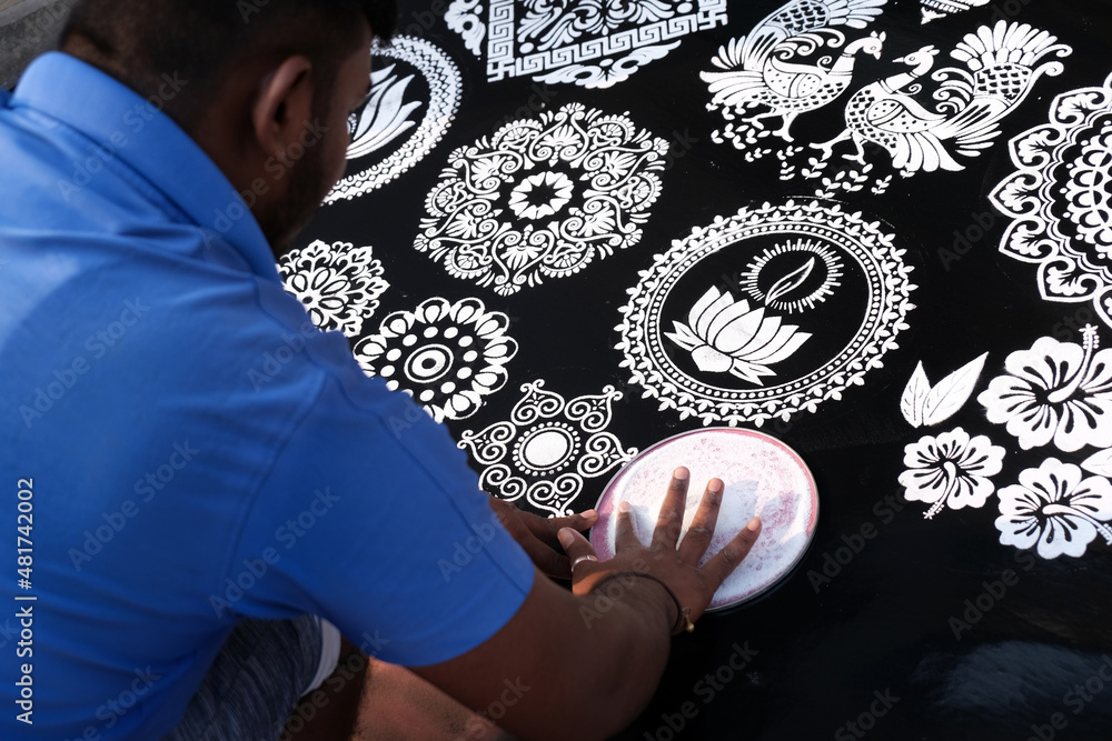 Indian Seller Man making rangoli from design patterns of Rangoli with ...