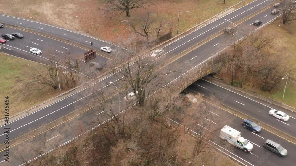 An aerial view of a highway intersection with light traffic, one road ...