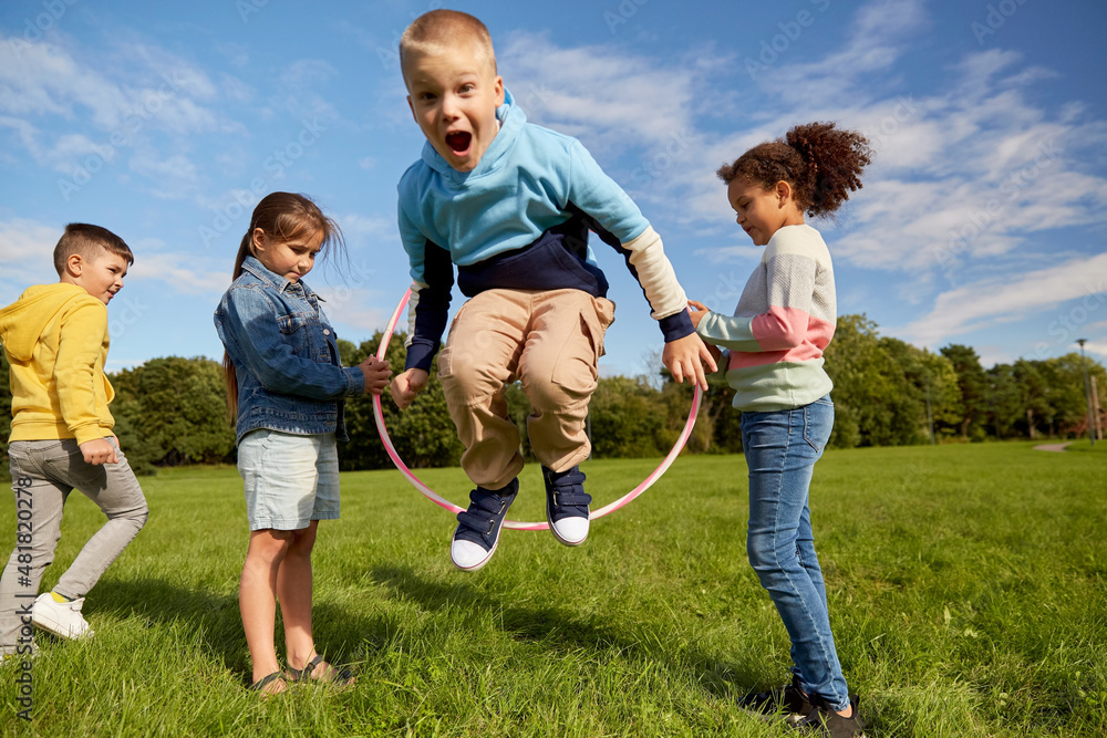 childhood, leisure and people concept - group of happy children playing ...