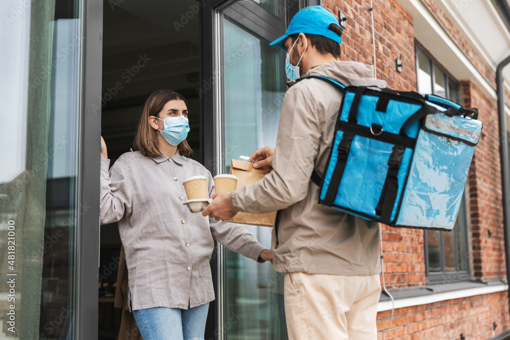 food shipping, pandemic and people concept - delivery man in mask with ...