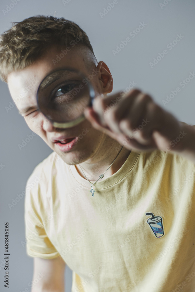 man looking through magnifying glass Stock Photo | Adobe Stock