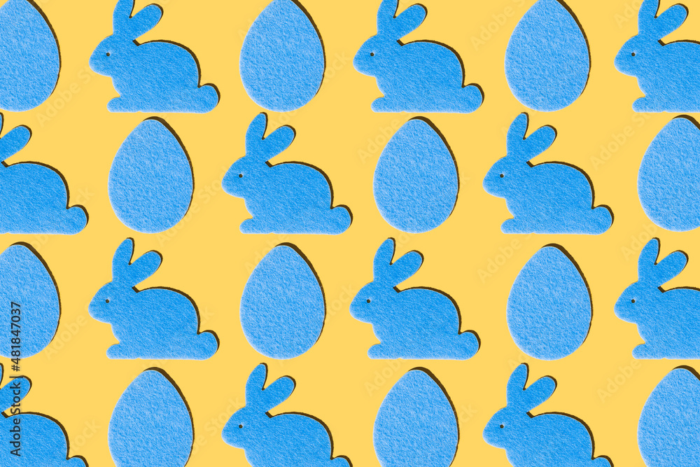 Blue rabbits and blue eggs pattern on a yellow background Stock Photo ...