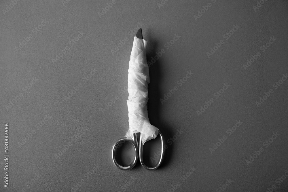 Scissors wrapped in white paper Stock Photo | Adobe Stock