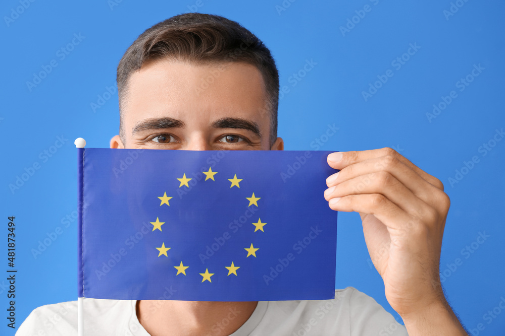 Young man with flag of European Union on color background Stock Photo ...