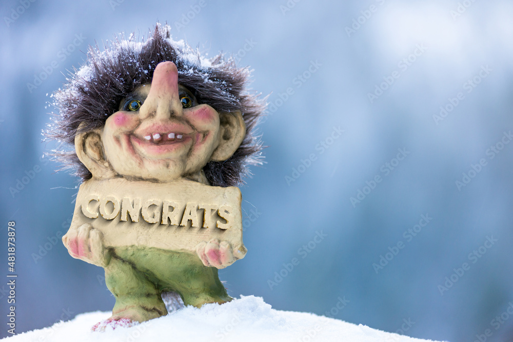Cute happy troll holding sign with the word congrats chiseled out. Soft ...