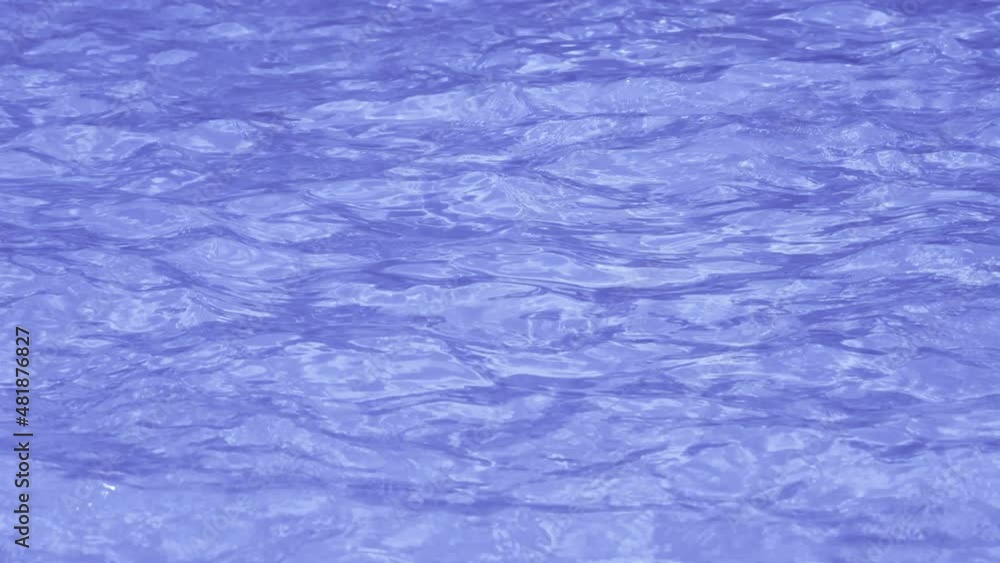 Pure transparent toned in purple water in the swimming pool with light ...