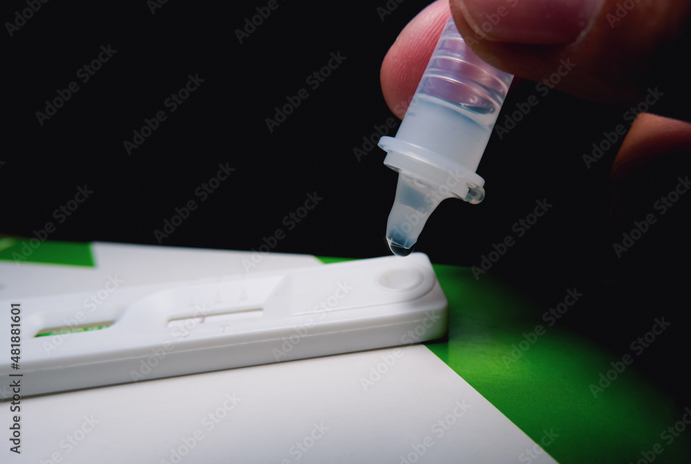 Own hand placing the droplet secretions sample into the SARS CoV-2 ...