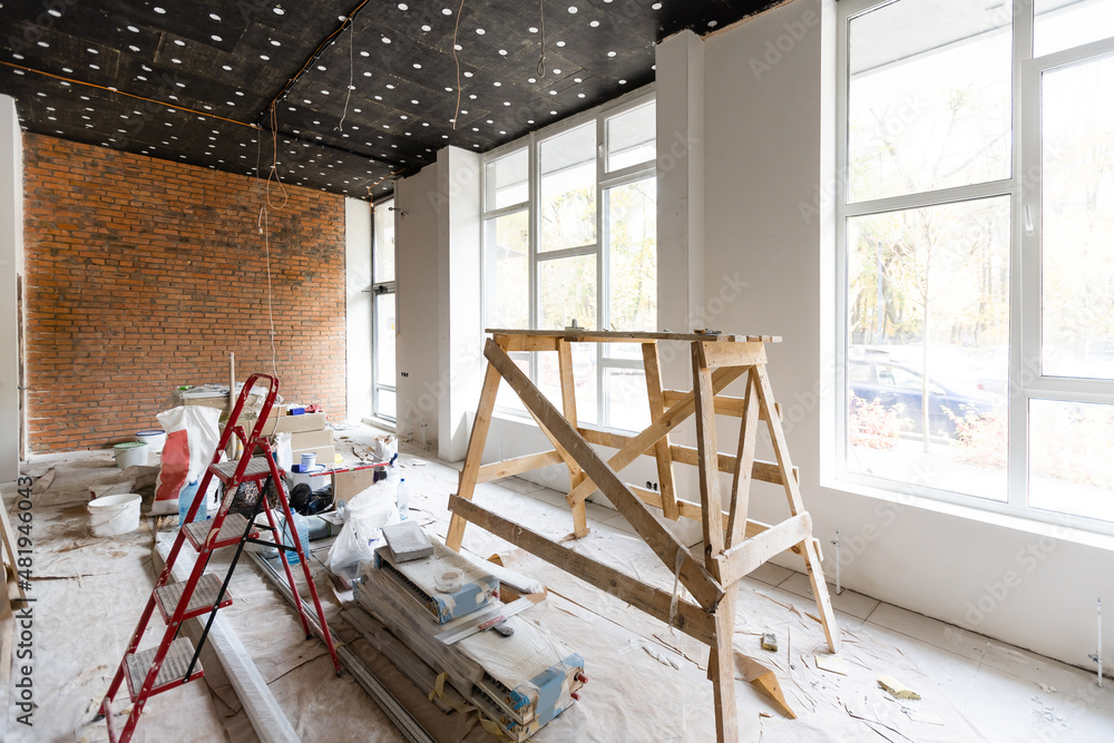 Workers are installing plasterboard for gypsum walls in apartment is ...