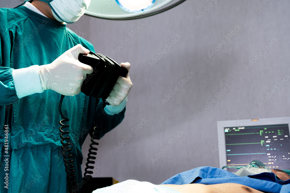 Selective focus at defibrillator while doctor use it to pump at chest ...