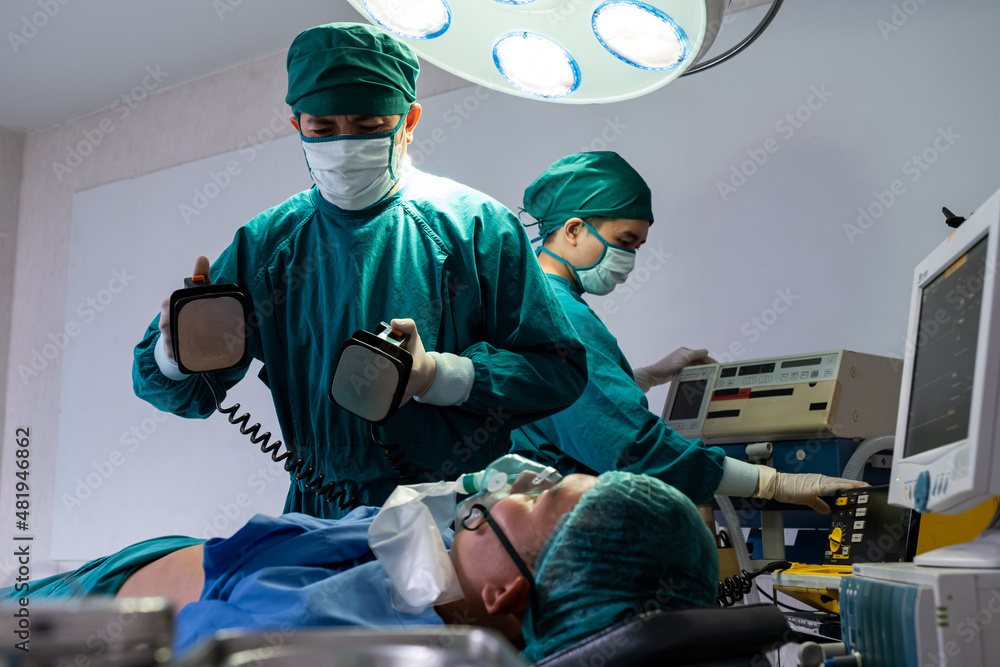 Selective focus at defibrillator while doctor use it to pump at chest of unconscious with low ...