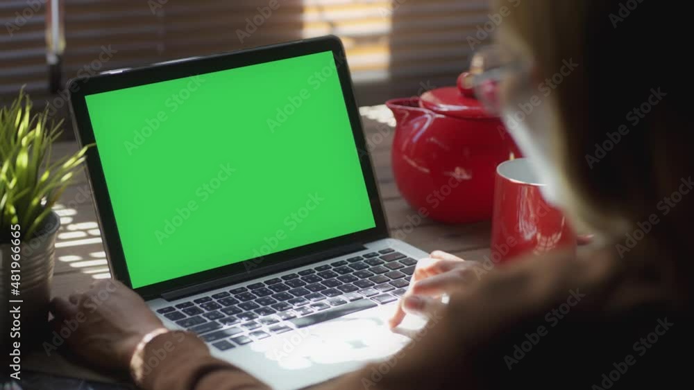 Over the shoulder shot of a business woman working in office interior ...