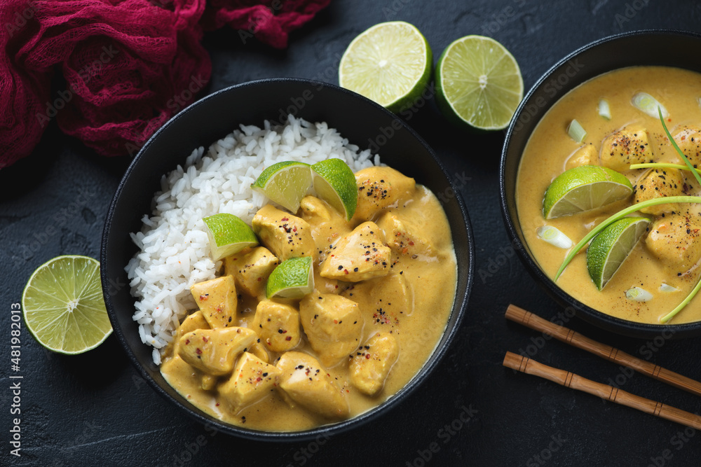 Bowls of yellow curry with chicken meat and white rice, elevated view ...
