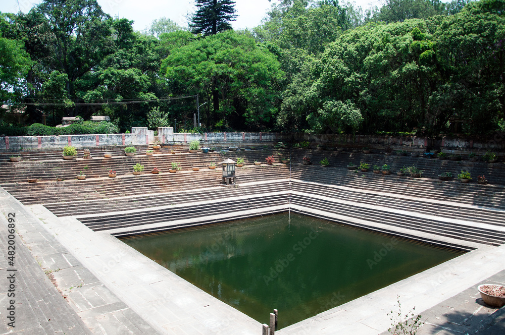 Beautiful antique man made water pond with steps at Nandi Hills, or ...