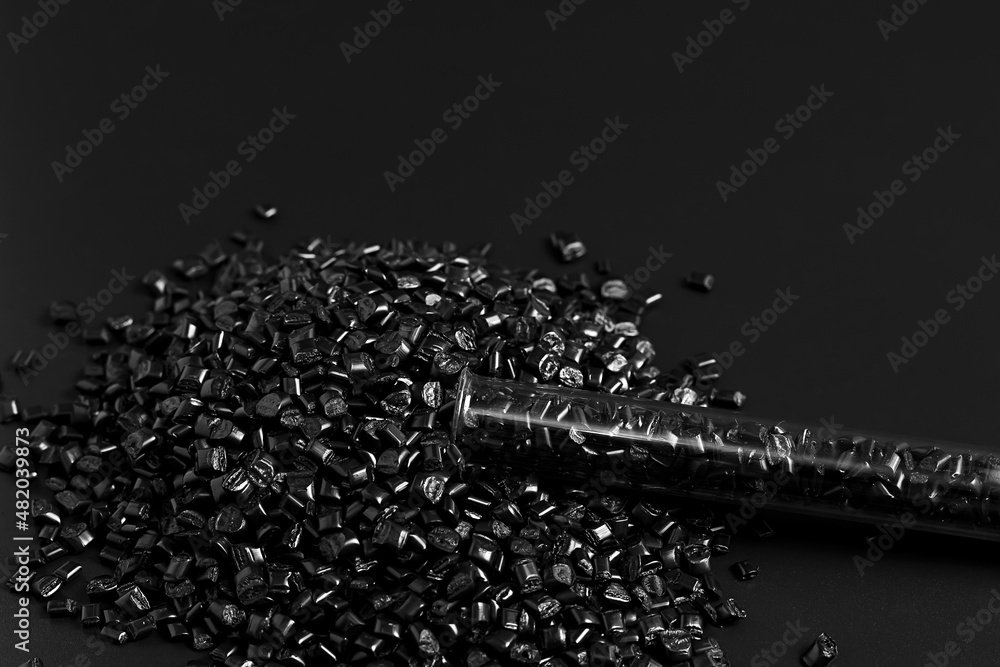 Many black granules of polypropylene, polyamide in a test tube ...