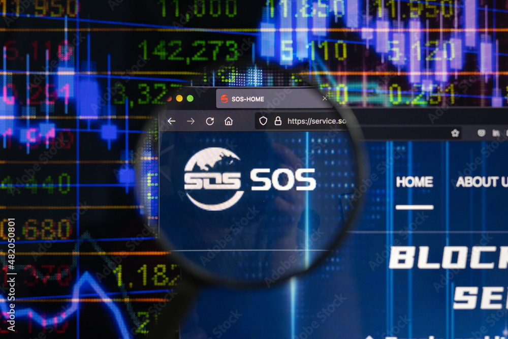 SOS company logo on a website with blurry stock market developments in the background, seen on a ...