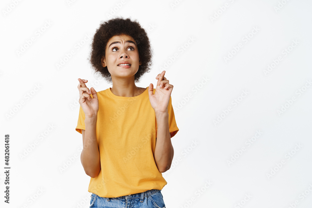 Hopeful attractive african girl praying, making wish with fingers ...